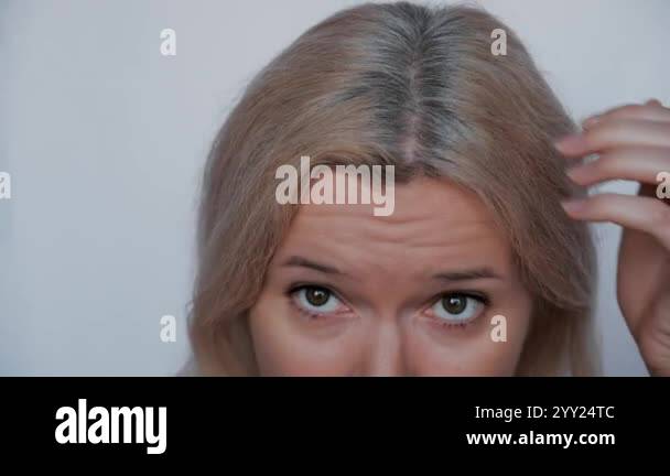 Pretty Woman is Checking Roots of Hair before Bleaching and Toning. Dry ...