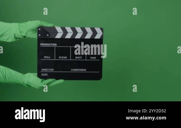 Movie Clapper board clapped by Hands on green screen camera background ...