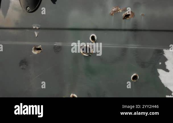 Closeup view highlighting bullet holes in a metal surface, showcasing ...