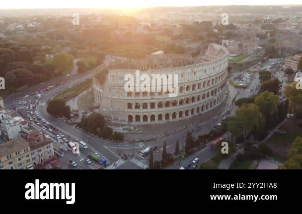 A stunning sunset over the Colosseum in Rome, Italy. The warm golden ...