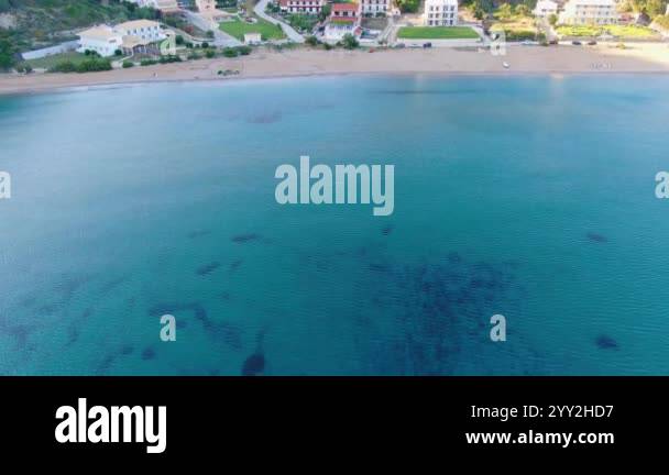 Aerial view of a sandy beach and turquoise ocean in Agios Georgios ...