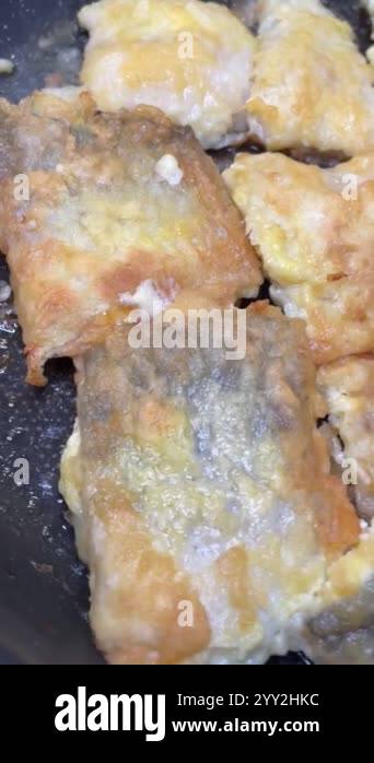 Fried fish in a frying pan in batter, oil, frying, fire, delicious ...
