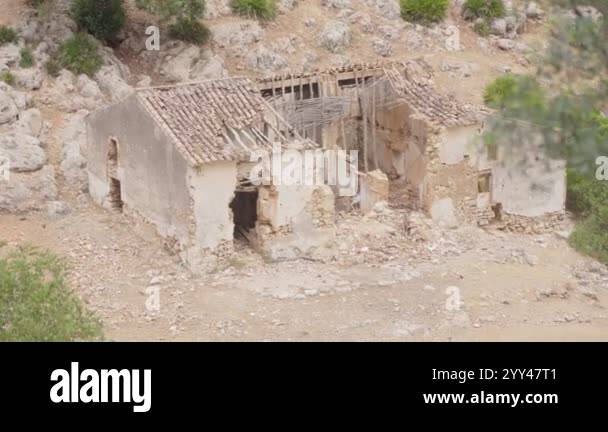 A dilapidated structure stands alone in a remote, rocky terrain. Nature ...