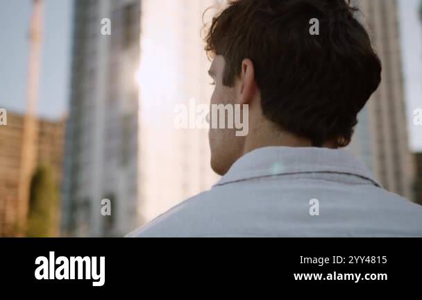 Back view close up Caucasian man turning head smiling happy cheerful ...