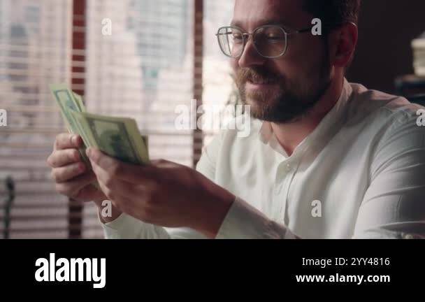 Joyful Caucasian businessman guy trader executive boss counting money ...