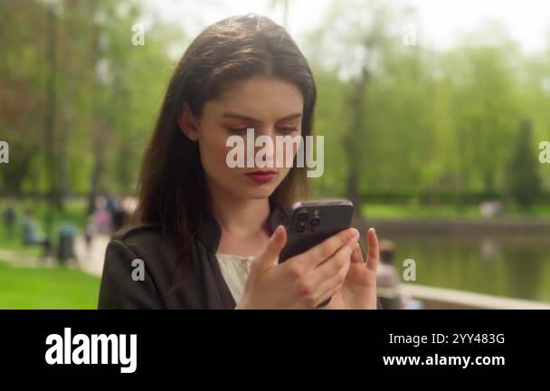 Serious Caucasian woman businesswoman texting mobile phone smartphone girl boss manager ...