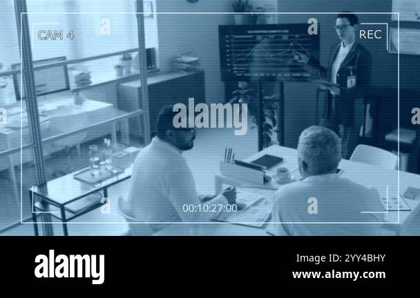 High angle CCTV camera shot of female clinic director explaining chart ...