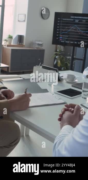 Vertical close-up shot of unrecognizable male patient signing medical ...
