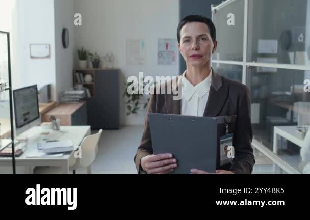 Portrait of middle-aged female medical director wearing formal suit ...