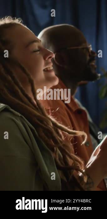 Vertical side chest up shot of Caucasian female spectator with ...