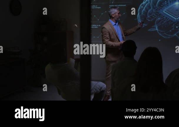 Biomedical engineer pointing at projection screen and explaining brain ...