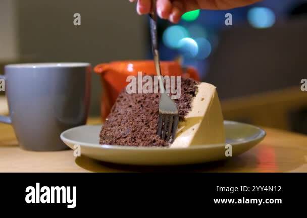 Biting a delicious piece of chocolate cake. Eating chocolate cake ...