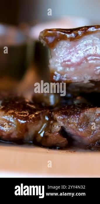 Extreme close up shot on piece of steak cutting using a kitchen knife ...