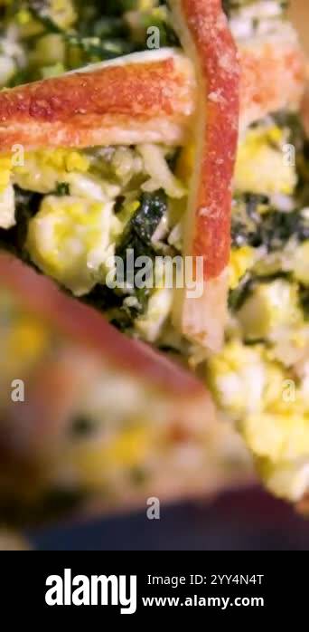 A delicious juicy and beautiful spinach egg and cheese pie Close up of ...