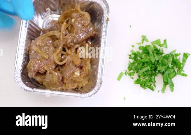 Chef decorates ready dish with fresh green herbs. Fried chicken liver ...
