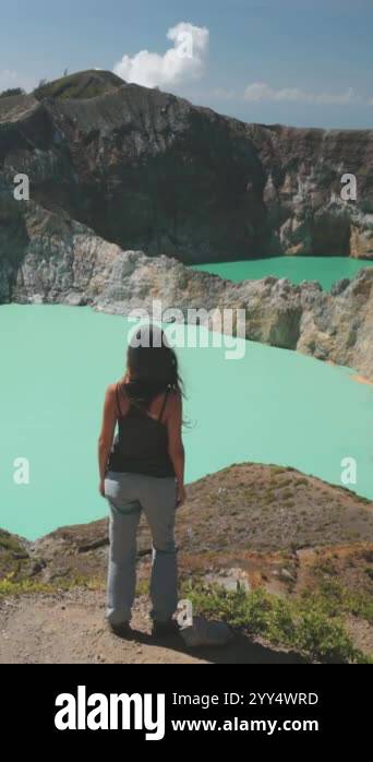 Vertical Screen Video. Woman looking on volcano mountain crater edge ...