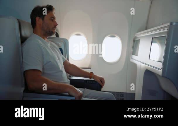 Scared Male Passenger Looking Out The Window Airplane. Man having a ...