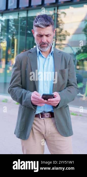Portrait of a cheerful young man smiling confidently in a modern urban ...