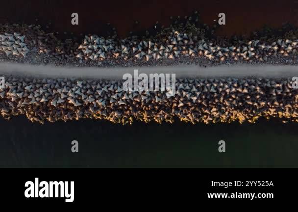 An aerial perspective of a breakwater with interlocking concrete blocks ...