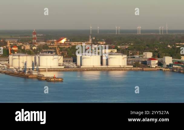 Large white storage tanks labeled 'VENT' near a port in Ventspils ...