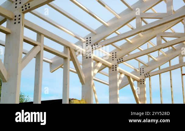 The video shows a wooden structure's framework with beams and trusses ...