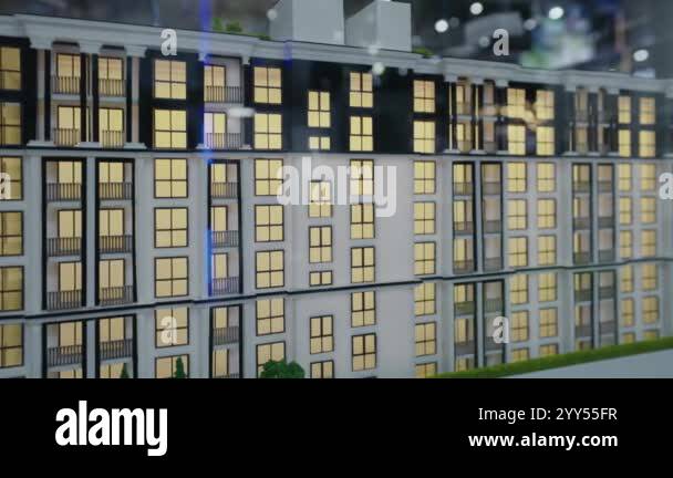 Miniature model of apartment building with glowing windows. Property ...