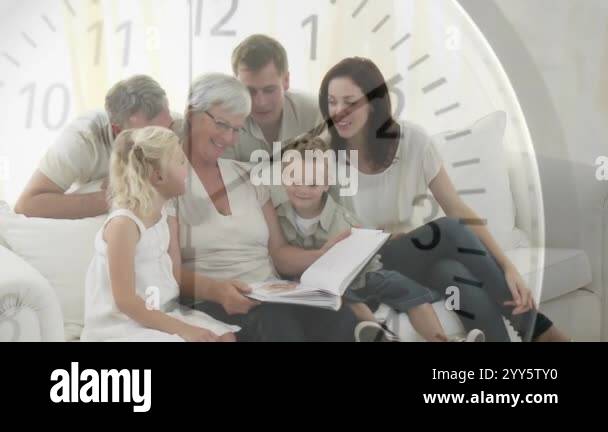 Clock animation over multi-generational family reading book together on ...