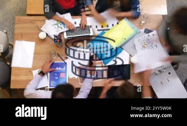 Film reel animation over group of people collaborating at desk with ...