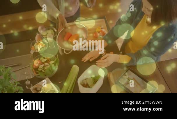 Preparing vegetables in kitchen, colorful bokeh animation over cooking ...