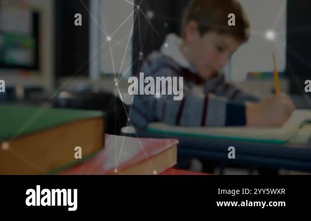 Network connections animation over boy studying at desk in classroom ...