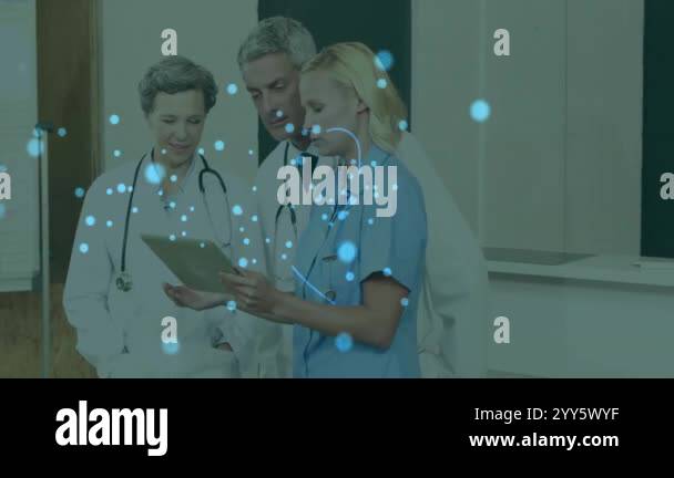 Reviewing patient information on tablet, doctors with cybersecurity ...