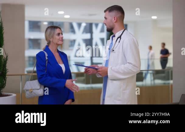 Professional doctor in a white coat and a stylish woman in a blue ...