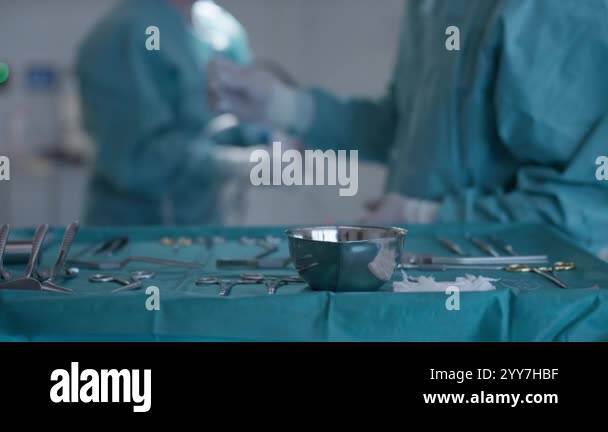 Close-up of surgical instruments arranged on a sterile table in a ...