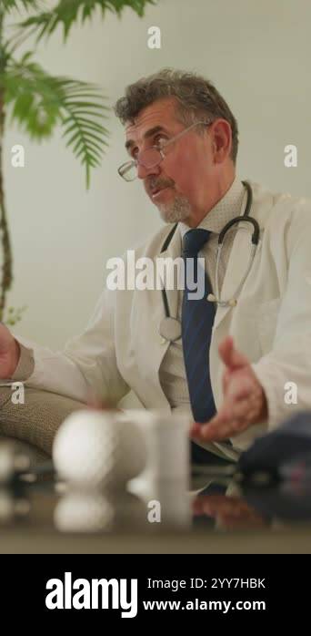 Vertical Screen: Doctor in a white coat with a stethoscope discusses ...