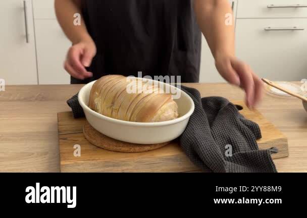 cook housekeeper put pork chop roll in baking dish covered with glaze ...