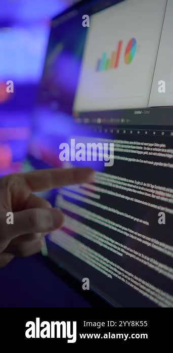 A hand interacting with complex code on a screen, showcasing digital ...