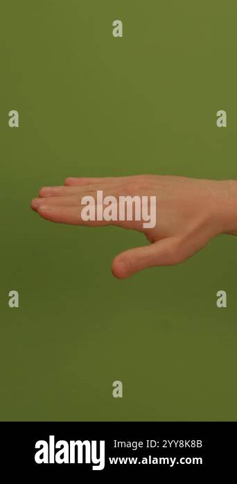 A human hand is extending forward in a clear pointing gesture against a ...