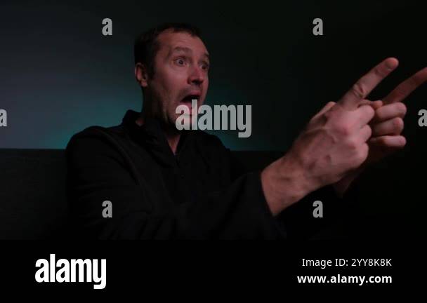 Man looking at camera expressing emotion of fear and stress. Grabbing ...