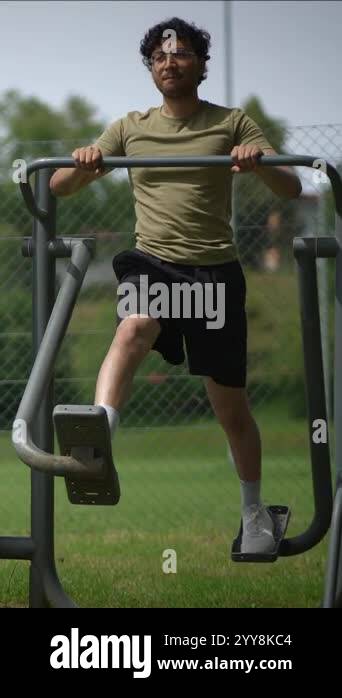 A young man involved in a tough outdoor fitness activity, demonstrating ...
