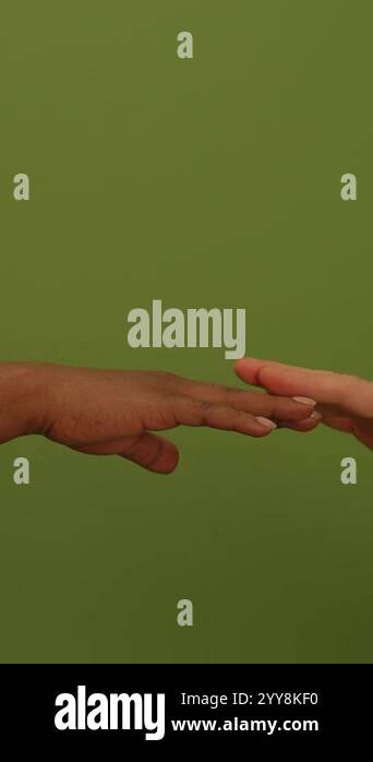 A closeup of a hand extending outward against a vibrant green ...