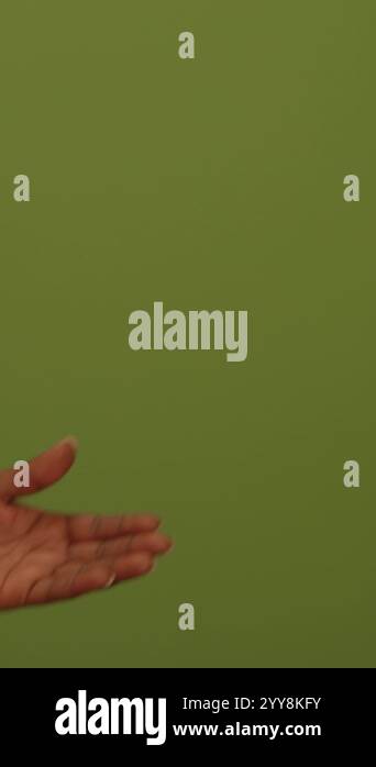 An open hand gesture against a vibrant green backdrop symbolizes ...