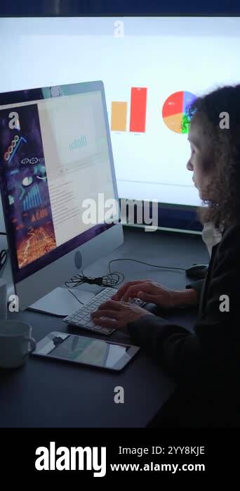A Dedicated Professional Woman Is Analyzing Data Using Multiple Screens