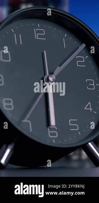 A closeup view of a classic black desk clock, showcasing its refined ...