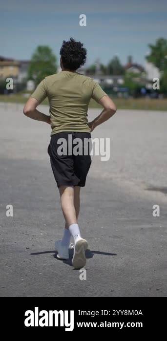 An individual taking a peaceful walk in a park while enjoying the ...