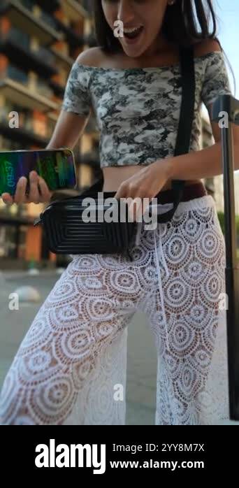 A trendy young woman proudly showcases her vibrant and unique style in ...