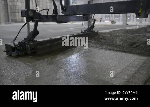 In an industrial setting, high tech machinery efficiently spreads and ...