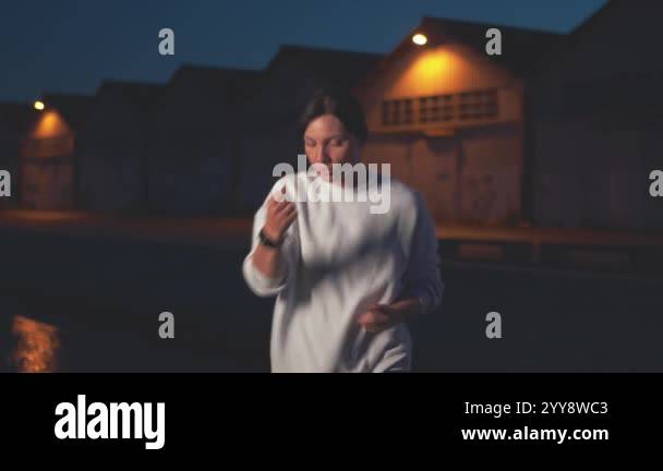 Active sporty woman practicing air boxing at night, showcasing ...