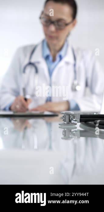 Stethoscope and medication history records form are lying on a glass ...