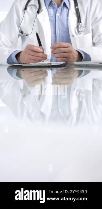 Unrecognizable doctor man in a blue shirt under a medical coat male ...