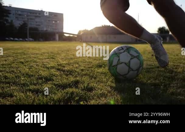 Male feet of professional footballer shows tricks with ball while ...